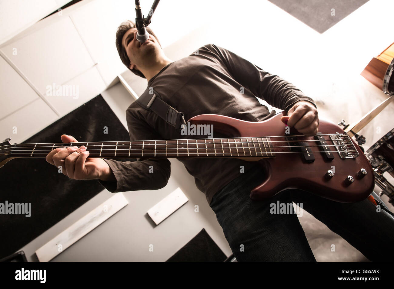 Black and white Portrait of a Rock singer playing bass in the rehearsal ...