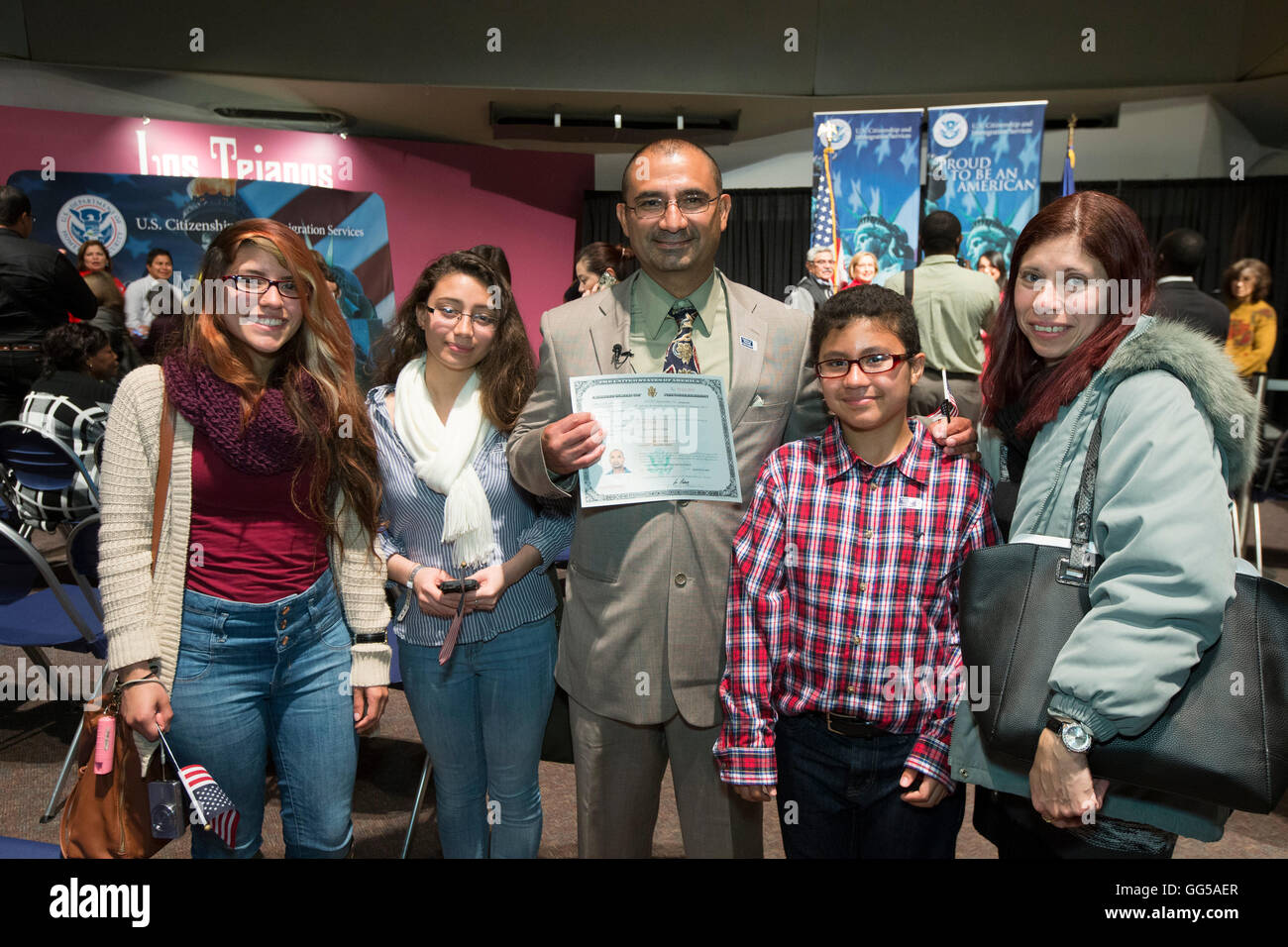 New United States citizen and family pose with citizenship certificates ...