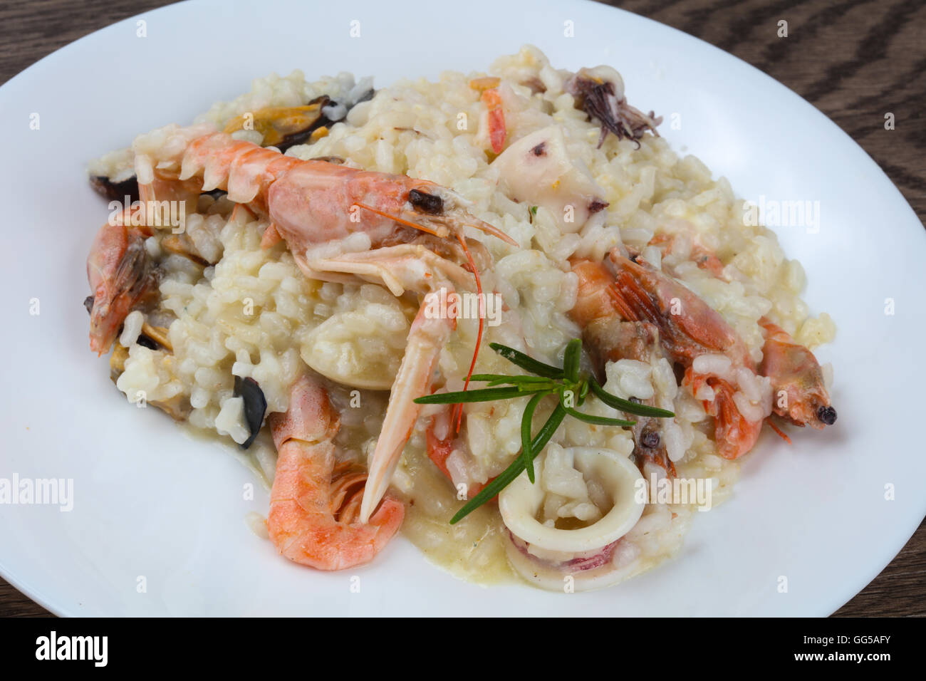 Seafood mix risotto with rosemary leaves Stock Photo - Alamy