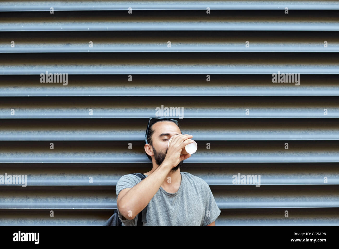 man drinking coffee from paper cup on street Stock Photo - Alamy