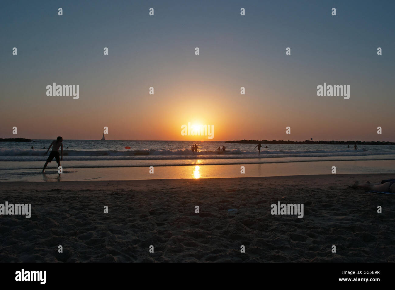 Tel Aviv, Israel, Middle East: a boy playing frisbee on the beach at ...