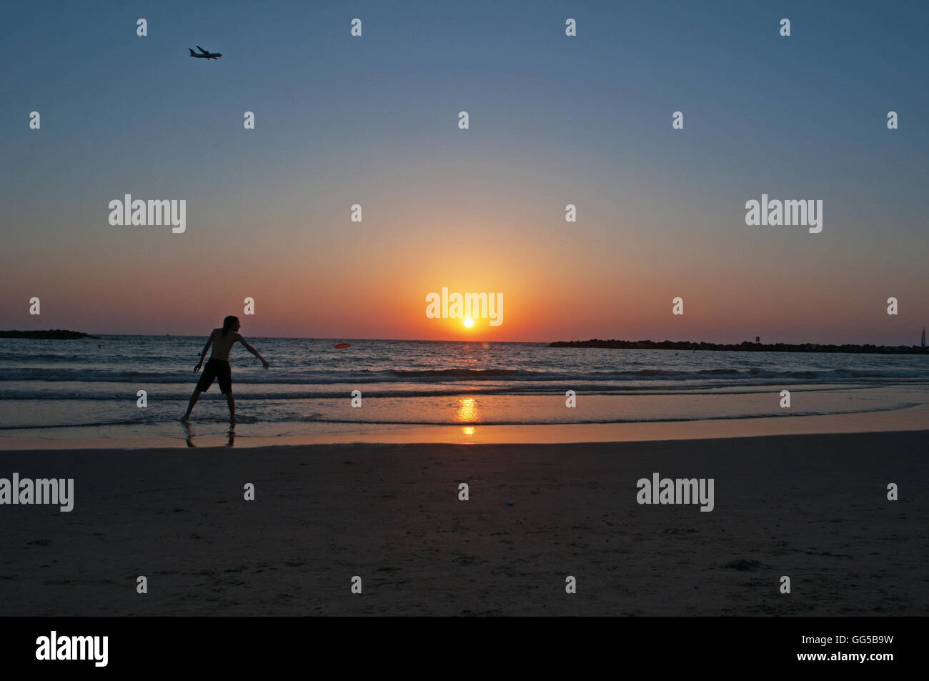 Tel Aviv, Israel, Middle East: a boy playing frisbee on the beach at ...