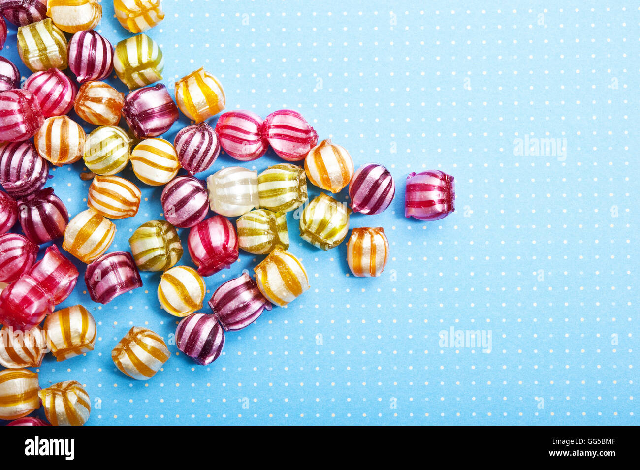 colorful candies scattered on blue background Stock Photo - Alamy