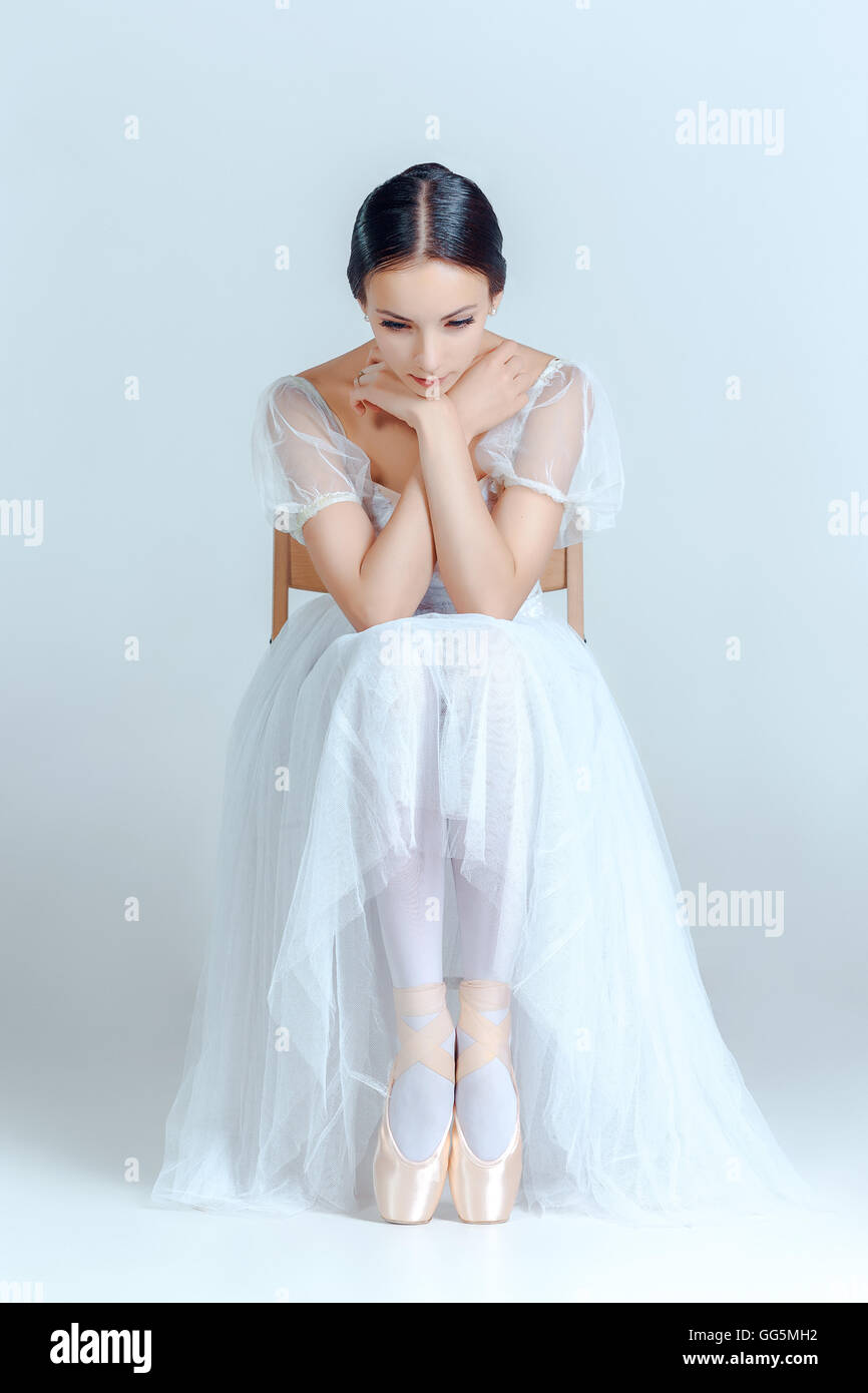 Professional ballerina resting after the performance and sitting with ...