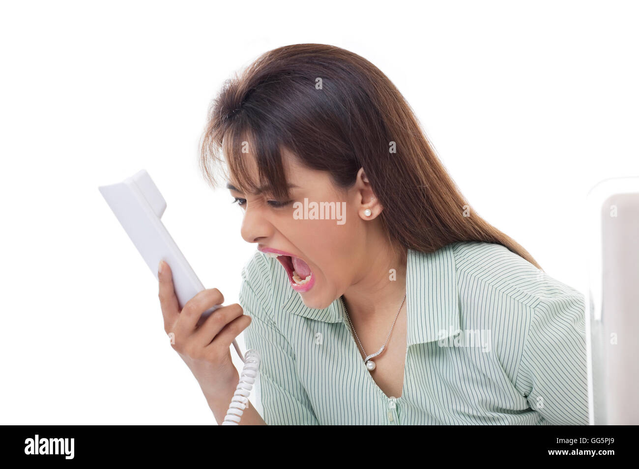 Close-up of young businesswoman screaming into phone receiver Stock ...