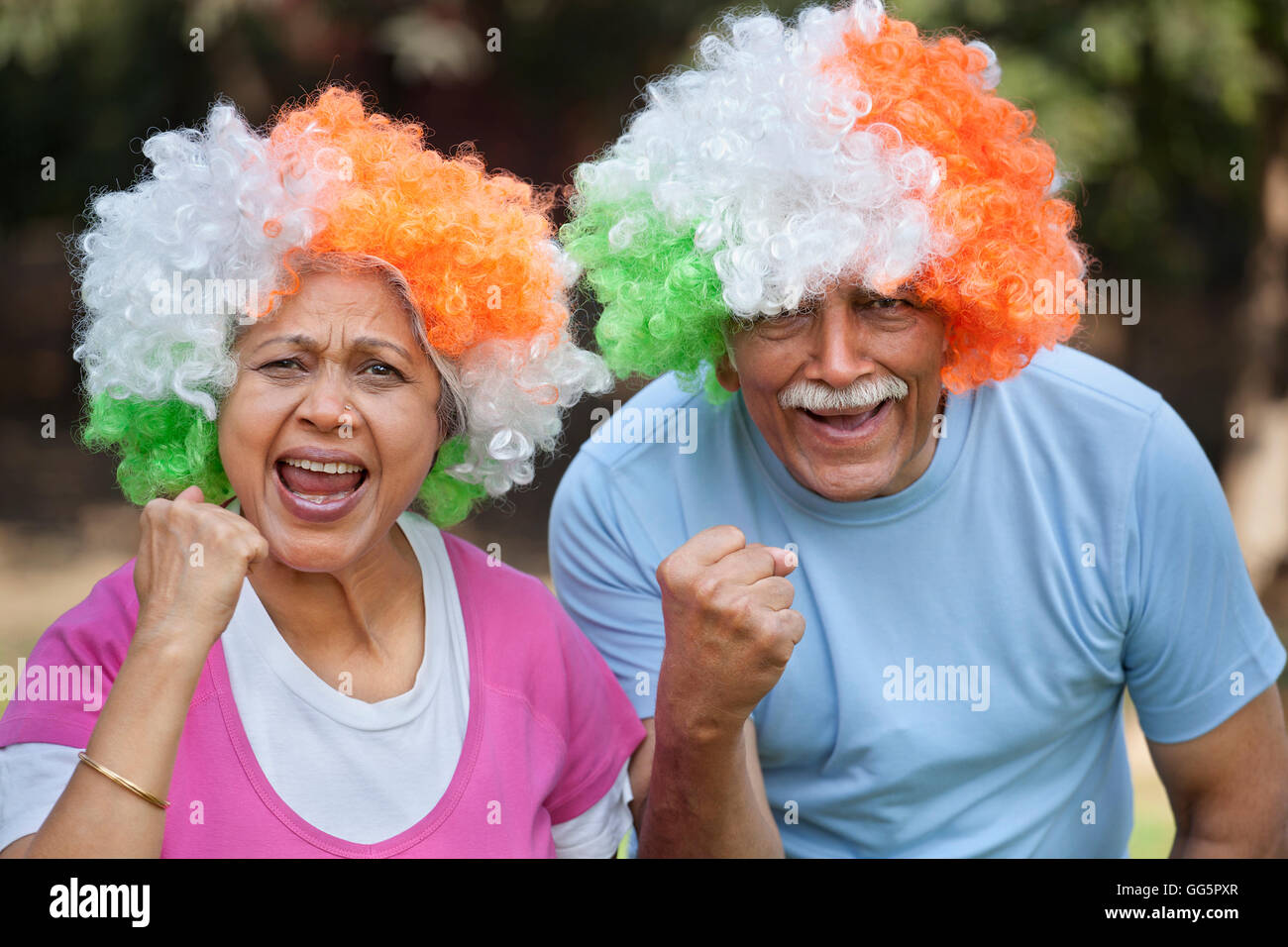 Portrait of couple cheering Stock Photo - Alamy