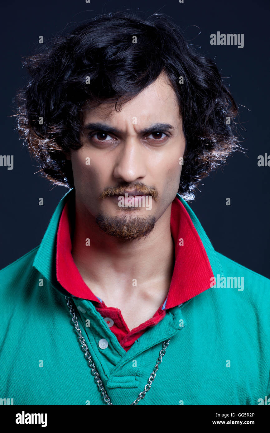 Portrait of angry young man grimacing Stock Photo - Alamy