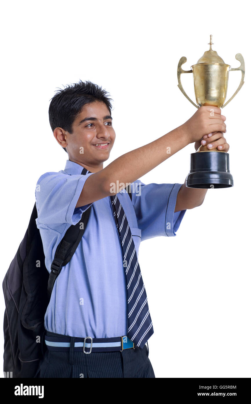 Happy young teenage boy holding trophy against white background Stock ...