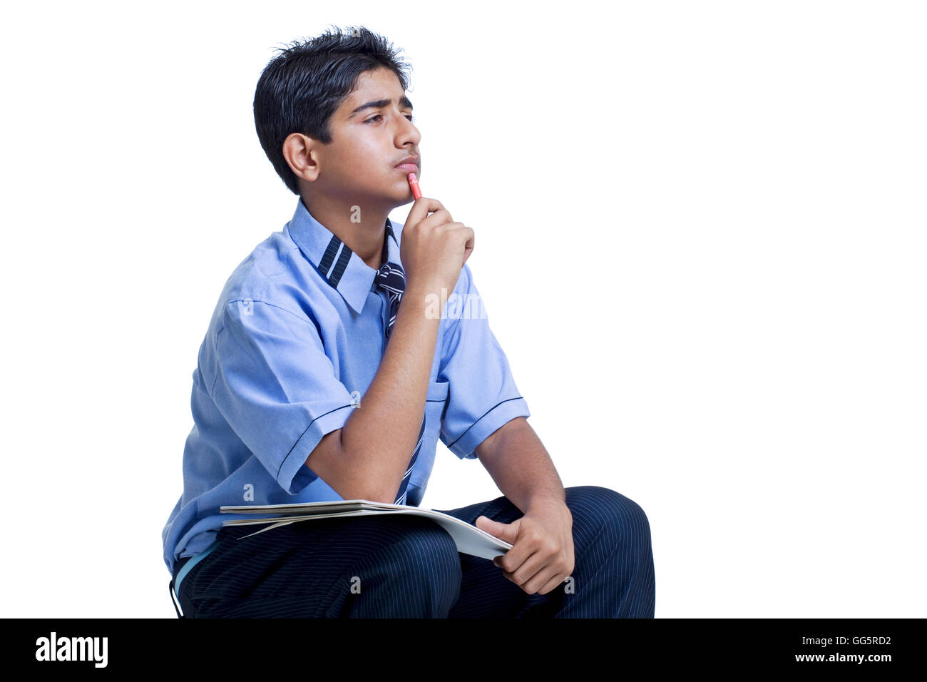 Thoughtful student studying over white background Stock Photo - Alamy