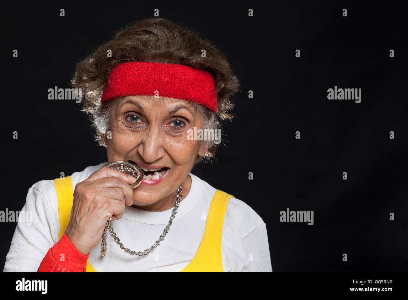 Close-up of senior woman biting locket Stock Photo - Alamy
