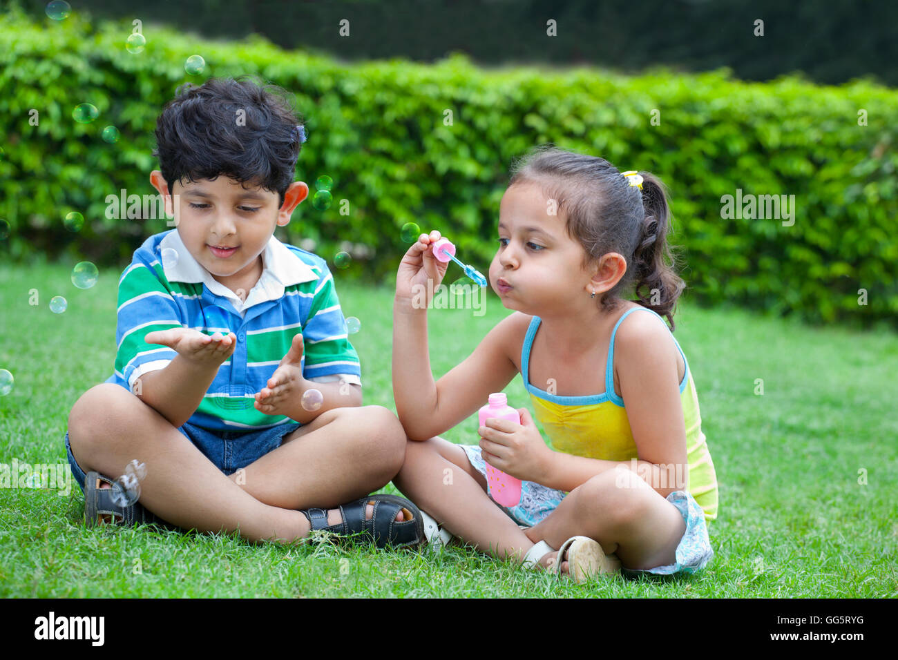 Cute little children playing with bubbles Stock Photo - Alamy