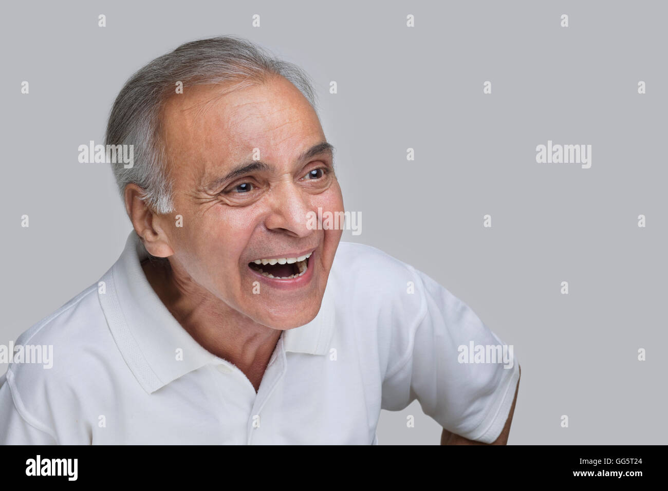Elderly man laughing over colored background Stock Photo - Alamy