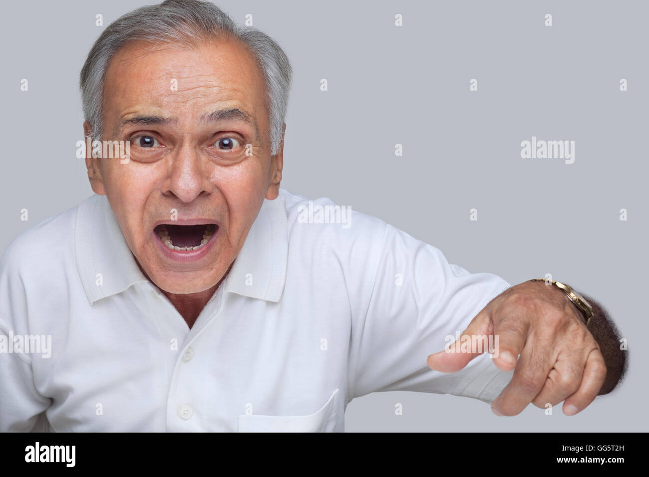 Old man pointing mouth hi-res stock photography and images - Alamy
