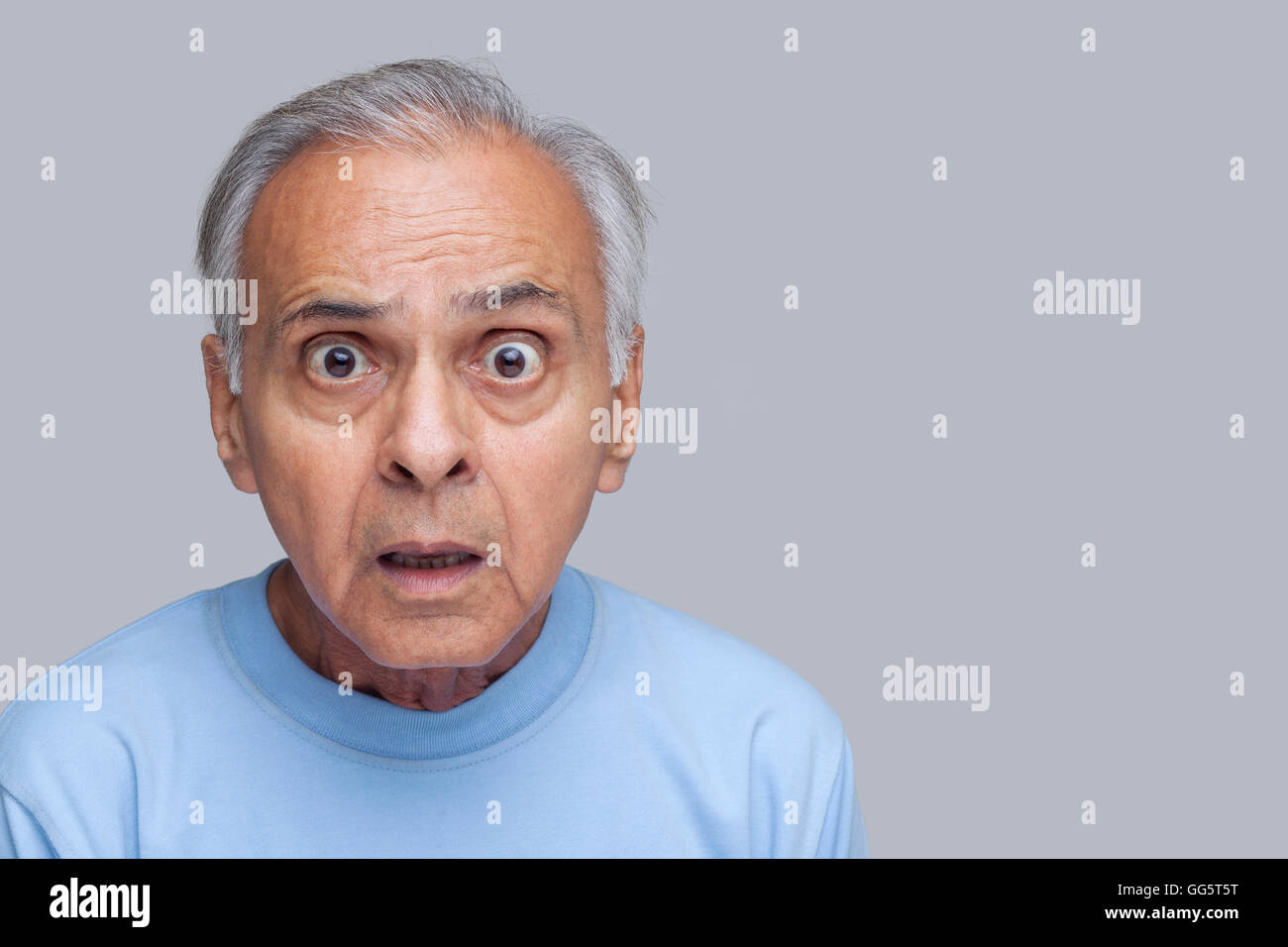 Angry old man over colored background Stock Photo - Alamy
