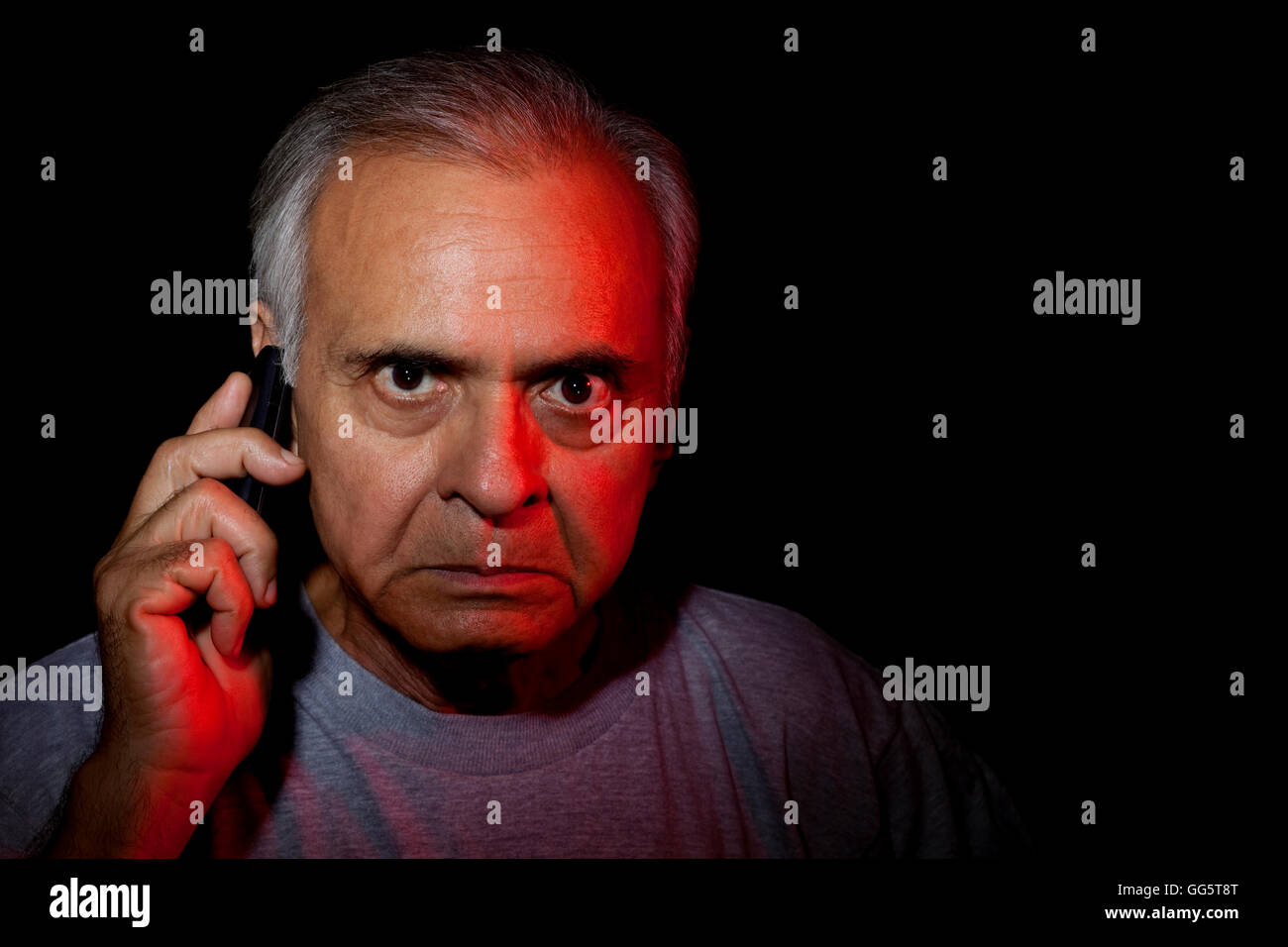 Close-up of senior angry man holding mobile phone Stock Photo - Alamy