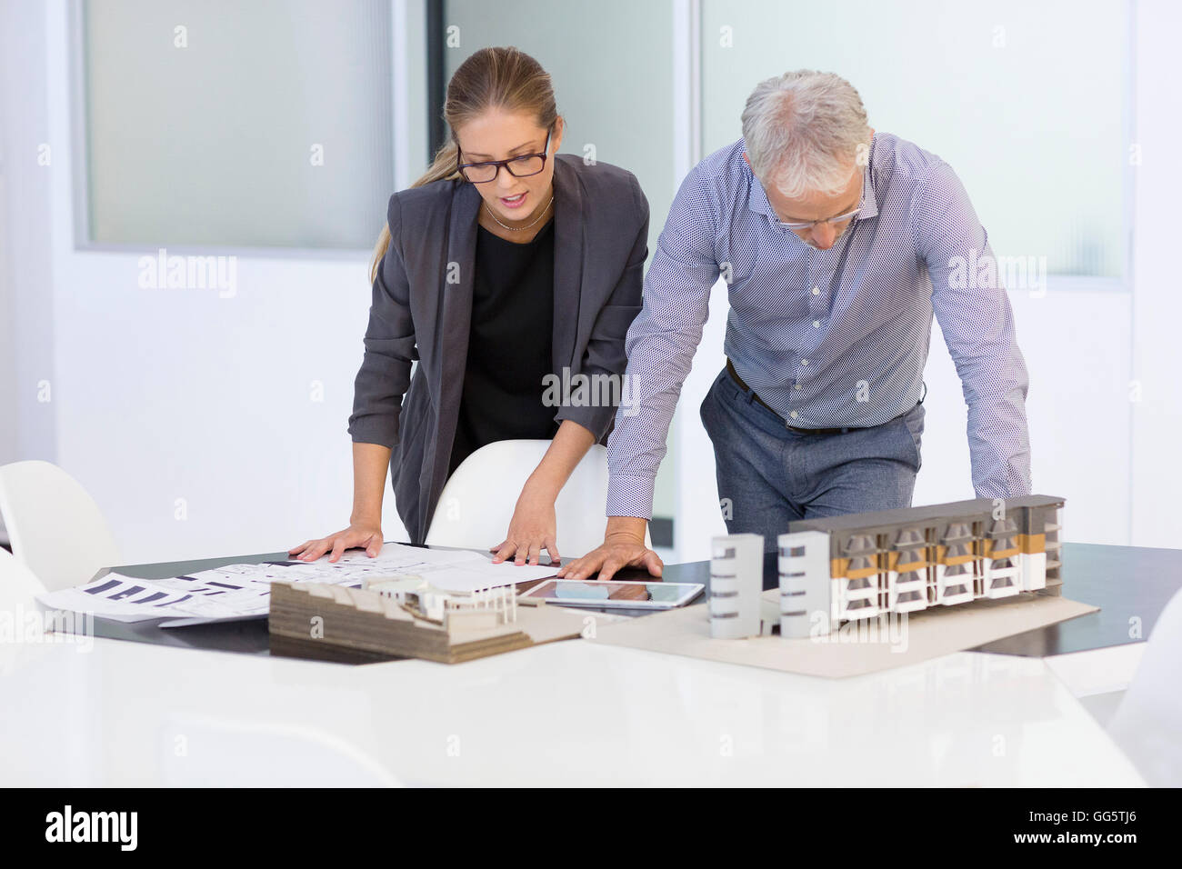 Design professionals examining architectural model in an office Stock ...