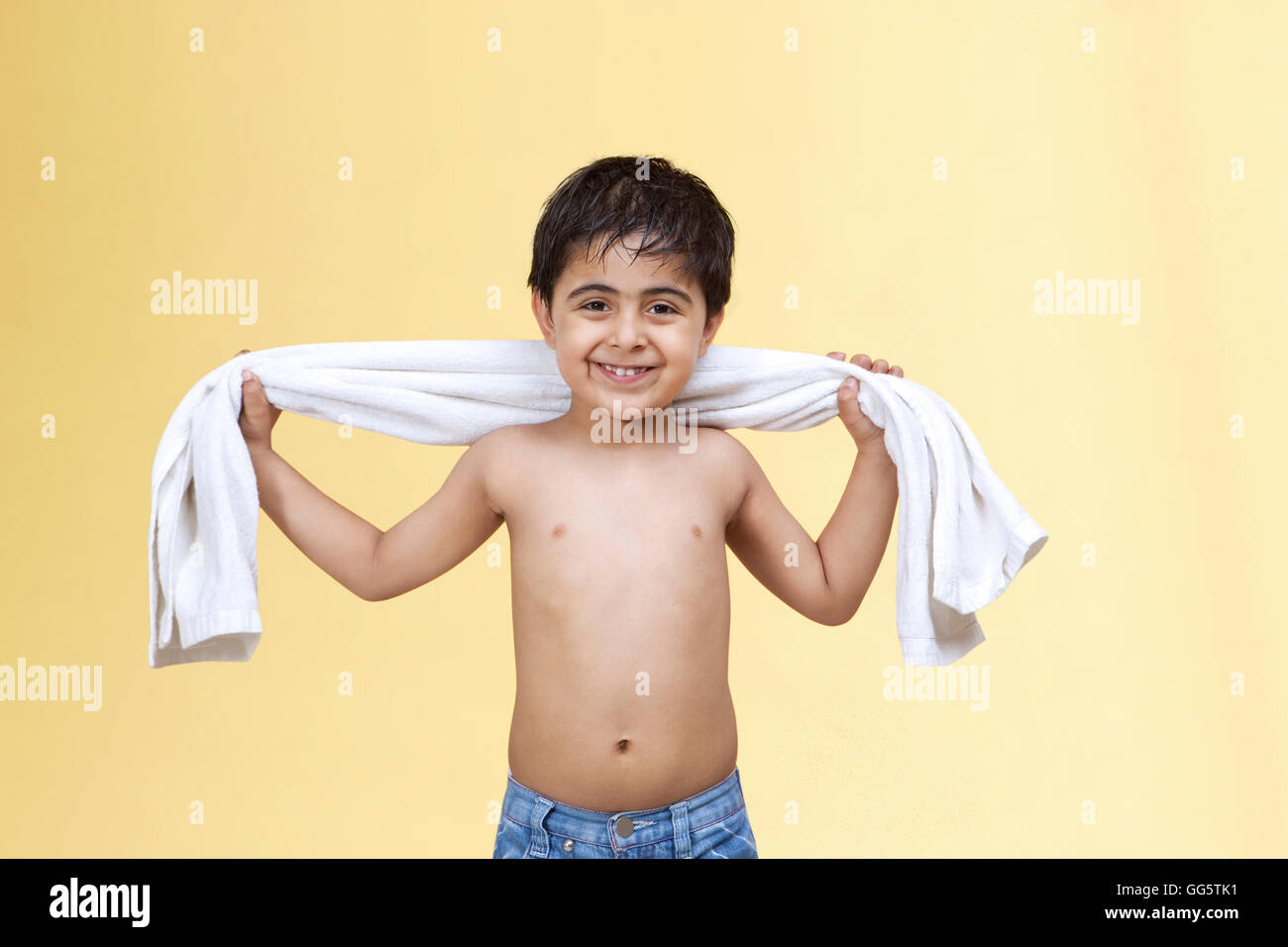 Cute little boy holding towel Stock Photo - Alamy