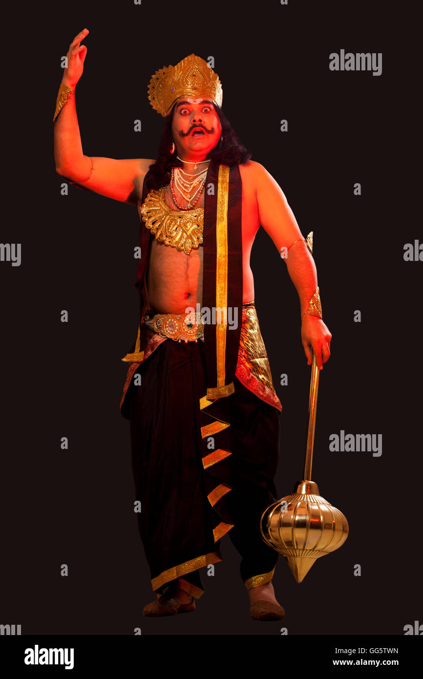Man dressed as Raavan holding a mace Stock Photo - Alamy