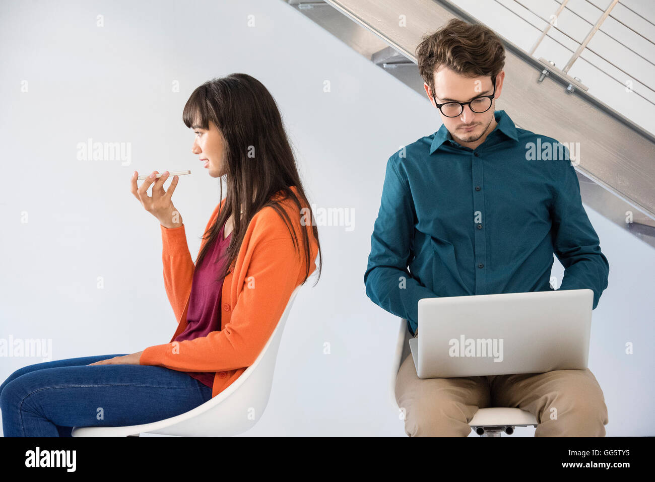 Two business people busy in different activities Stock Photo - Alamy