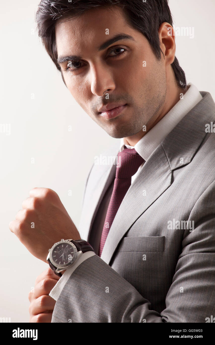 Portrait of confident young business man wearing watch Stock Photo - Alamy