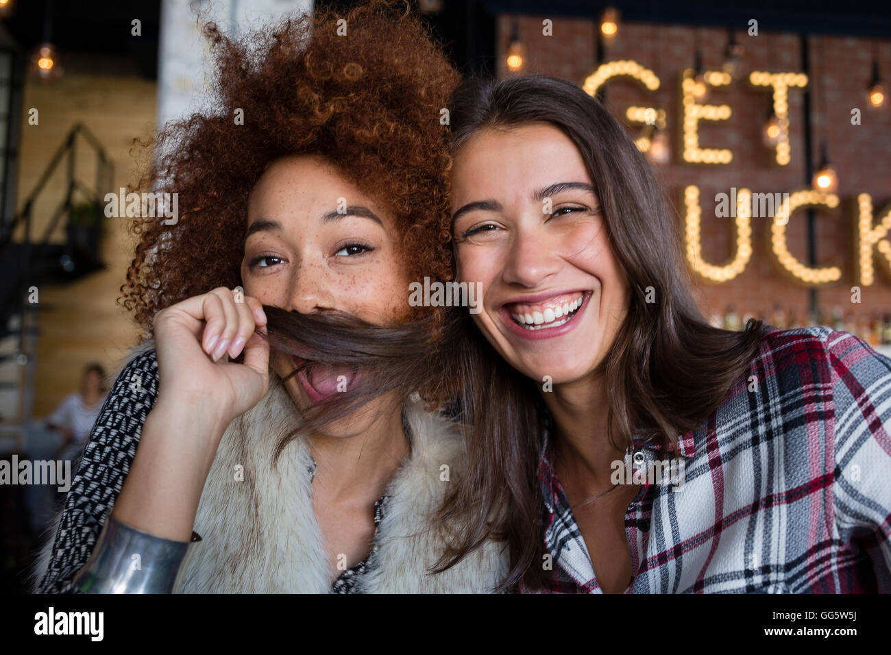 Portrait of happy female friends having fun in cafe Stock Photo - Alamy