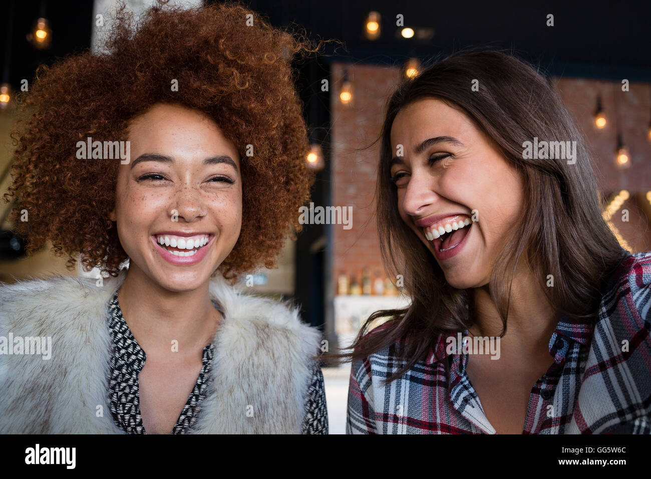 Portrait of happy female friends having fun in cafe Stock Photo - Alamy