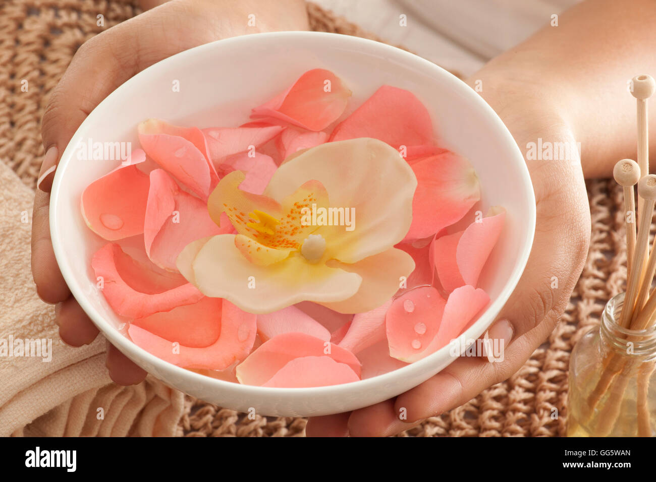 Rose petals and orchid in a bowl with reed diffuser Stock Photo - Alamy