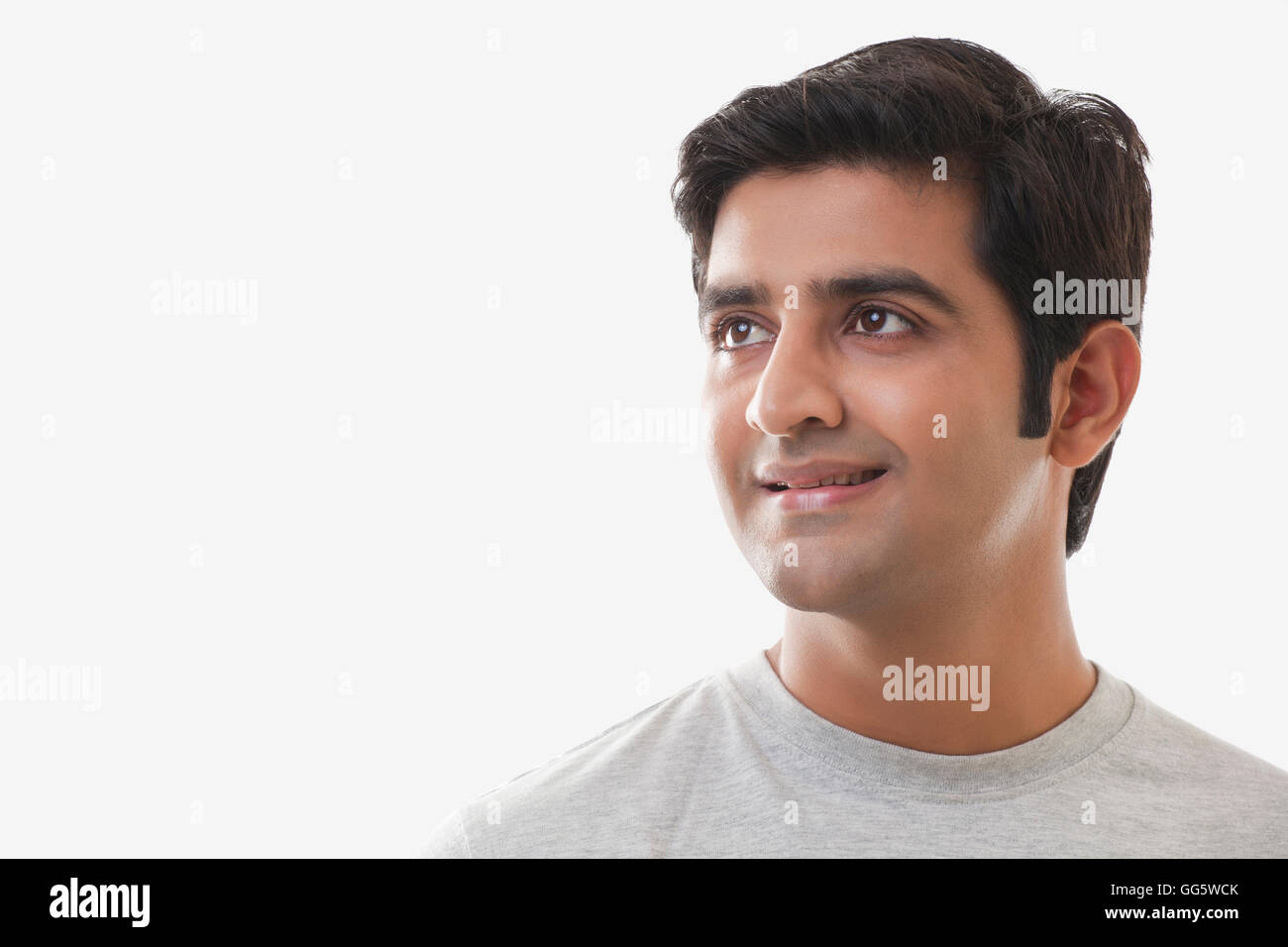 Smart young man smiling over white background Stock Photo - Alamy