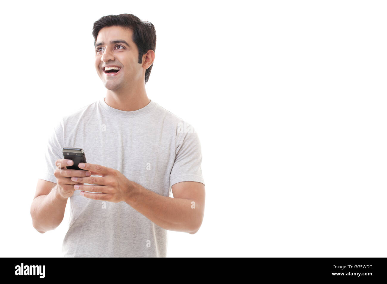 Cheerful young man holding cell phone on white background Stock Photo ...