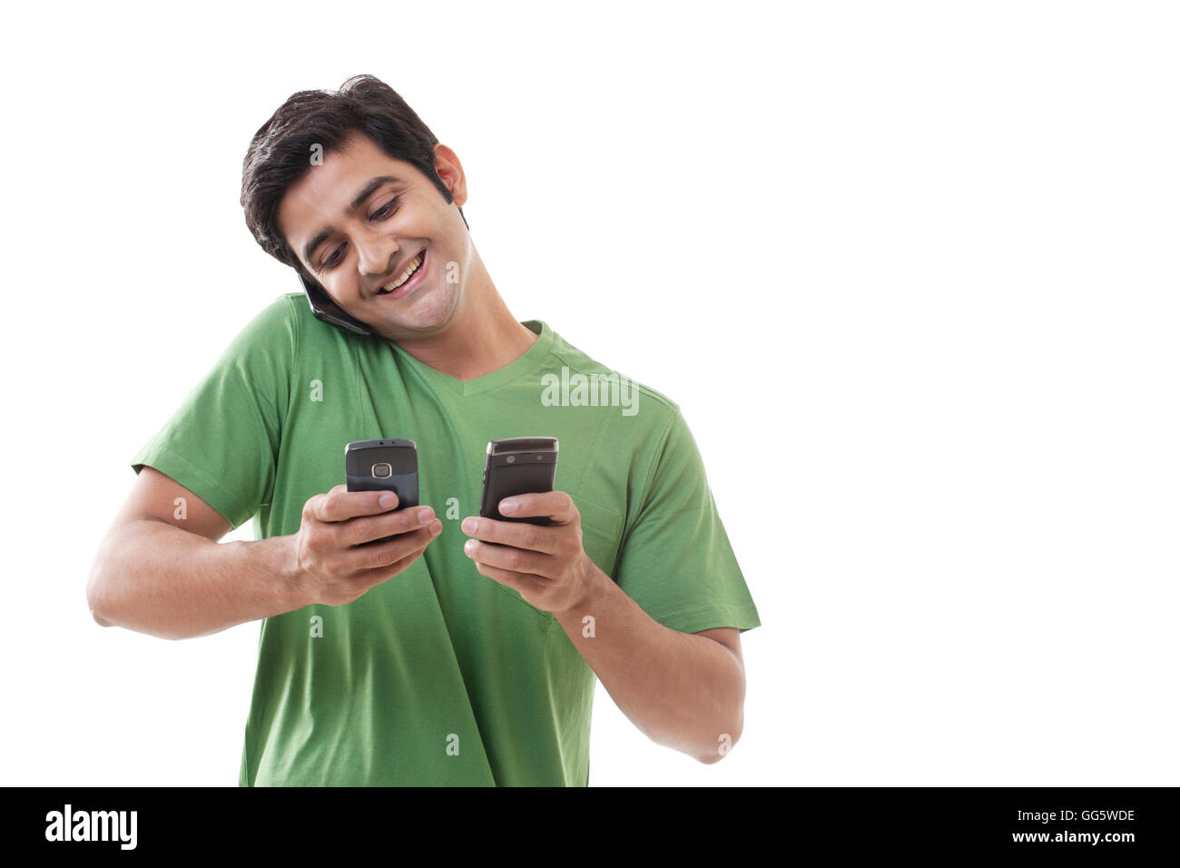 Handsome man using cell phone while text messaging over white ...