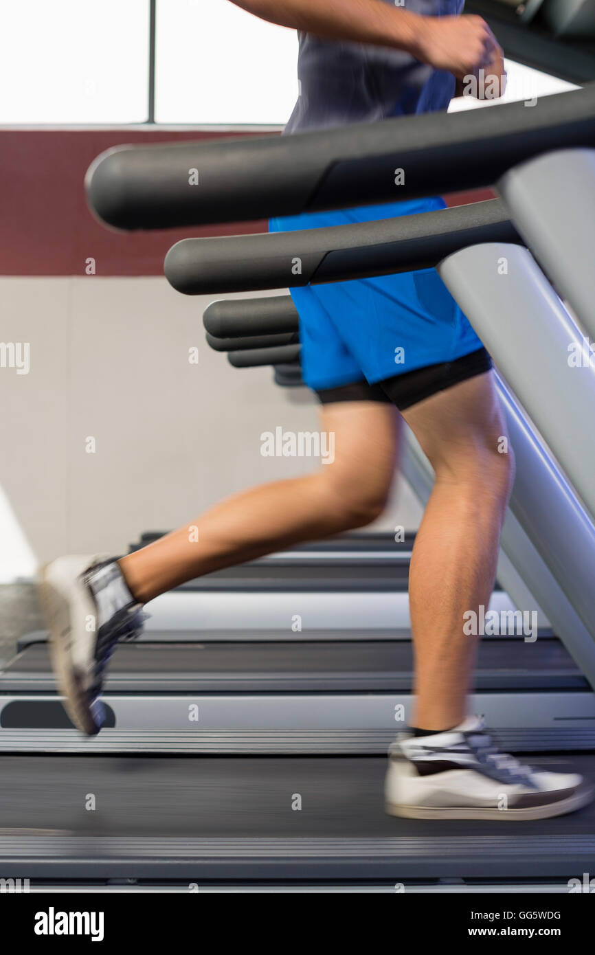 Low section view of a man running on a treadmill Stock Photo - Alamy