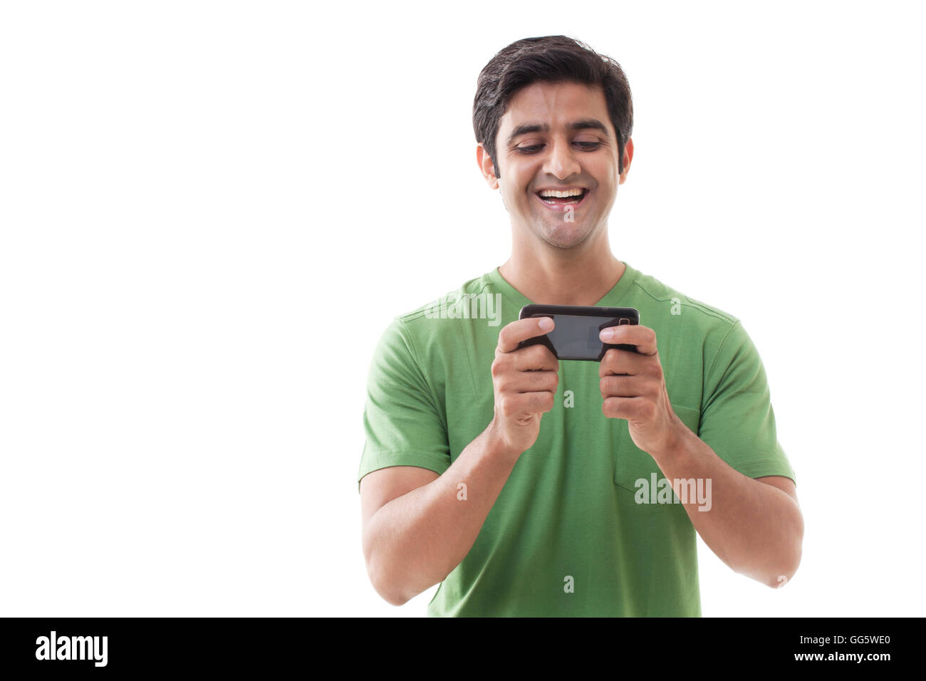 Cheerful young man texting over white background Stock Photo - Alamy