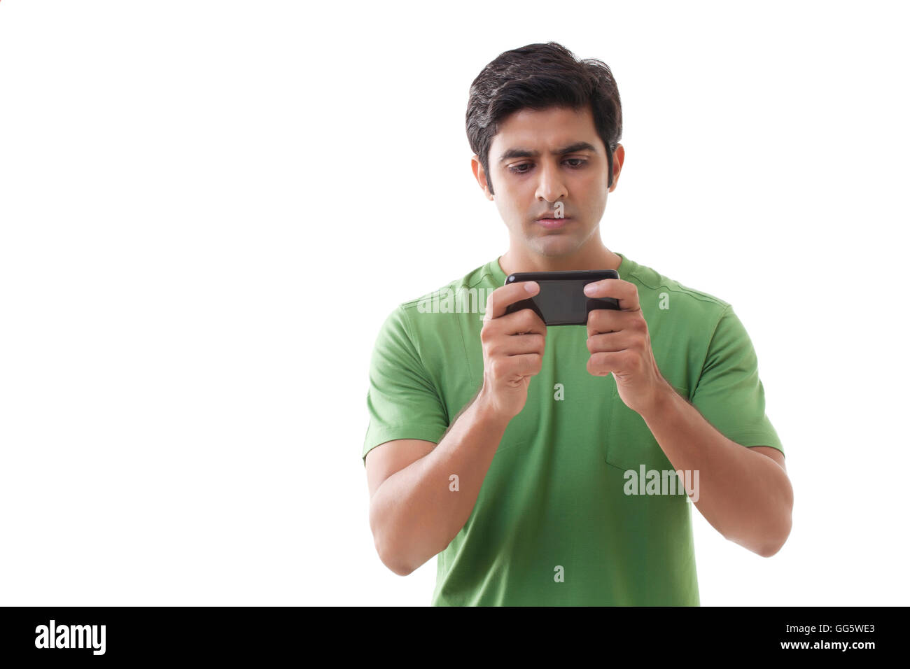 Serious young man reading text message over white background Stock ...