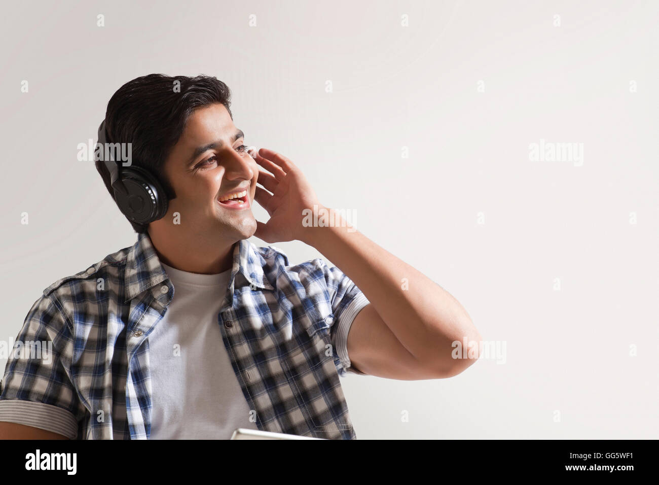 Cheerful young man wearing headphones Stock Photo - Alamy