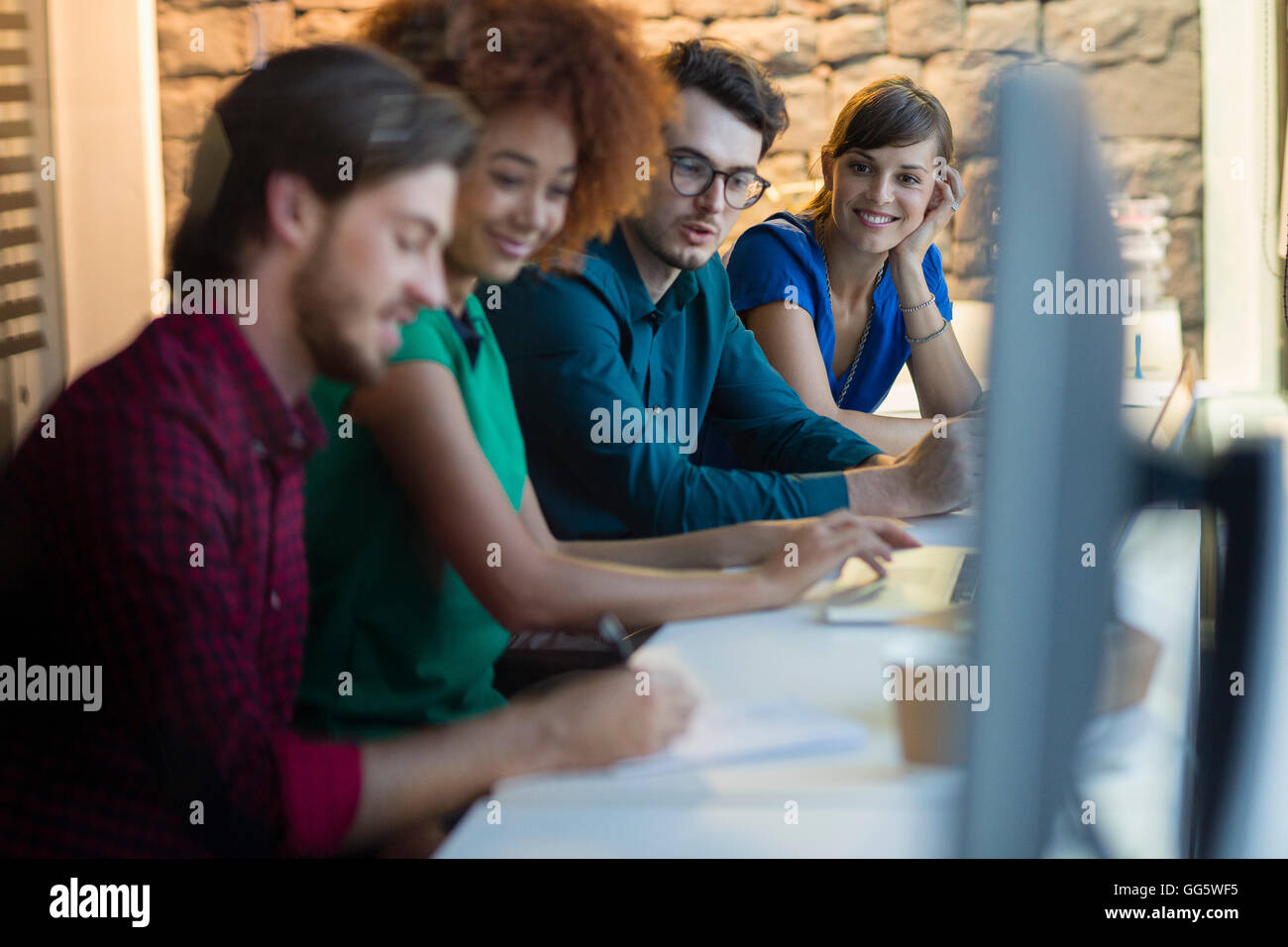 Design professionals working together in office Stock Photo - Alamy