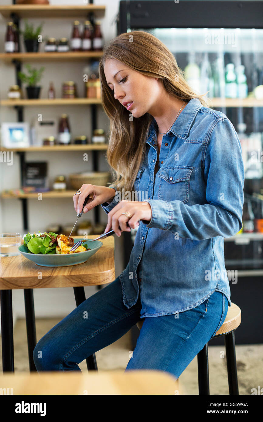 Woman eating lunch in a restaurant Stock Photo - Alamy