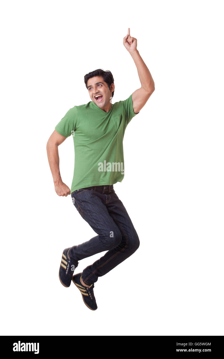 Excited young man jumping over white background Stock Photo - Alamy
