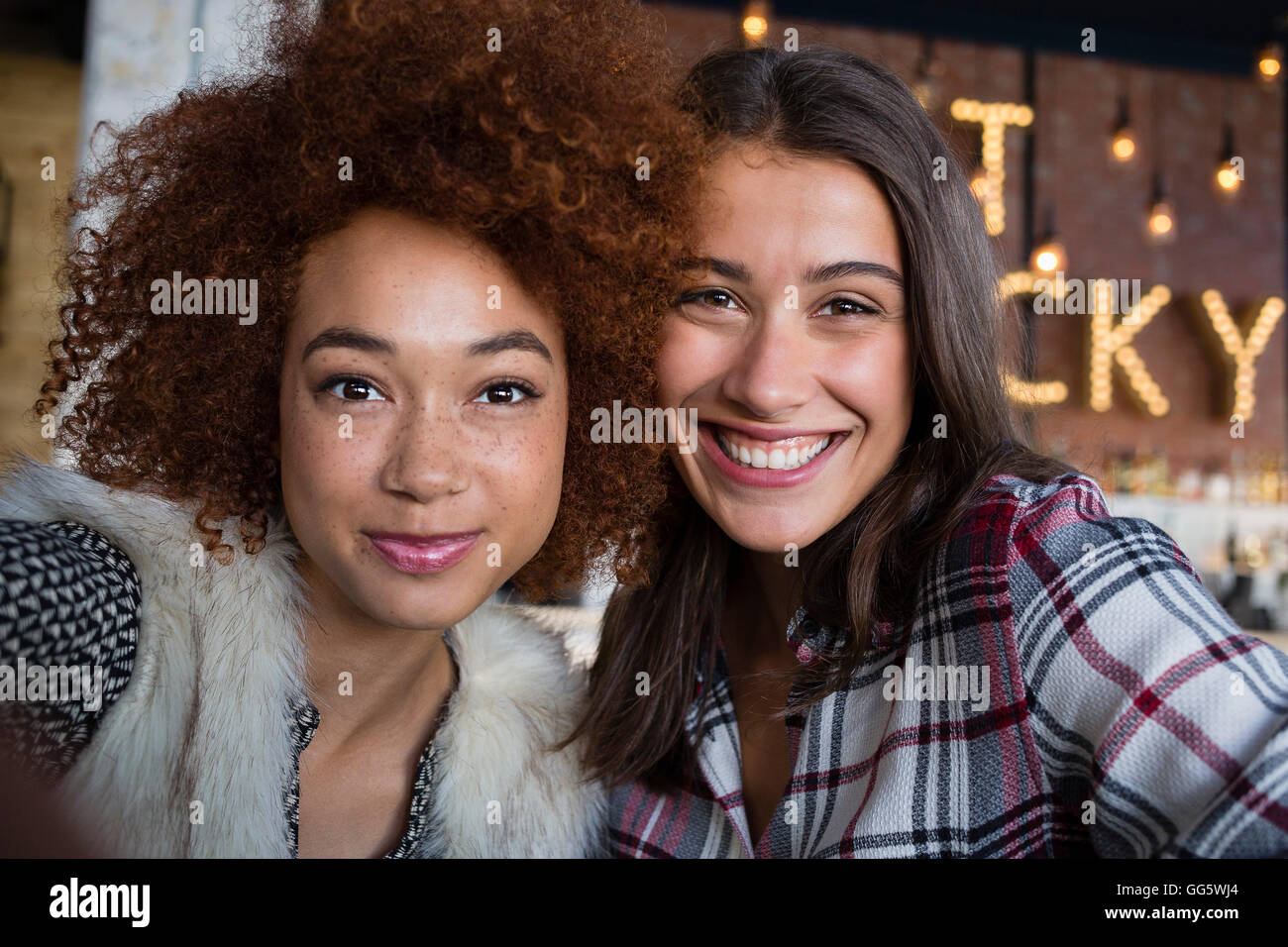 Portrait of happy female friends having fun in cafe Stock Photo - Alamy