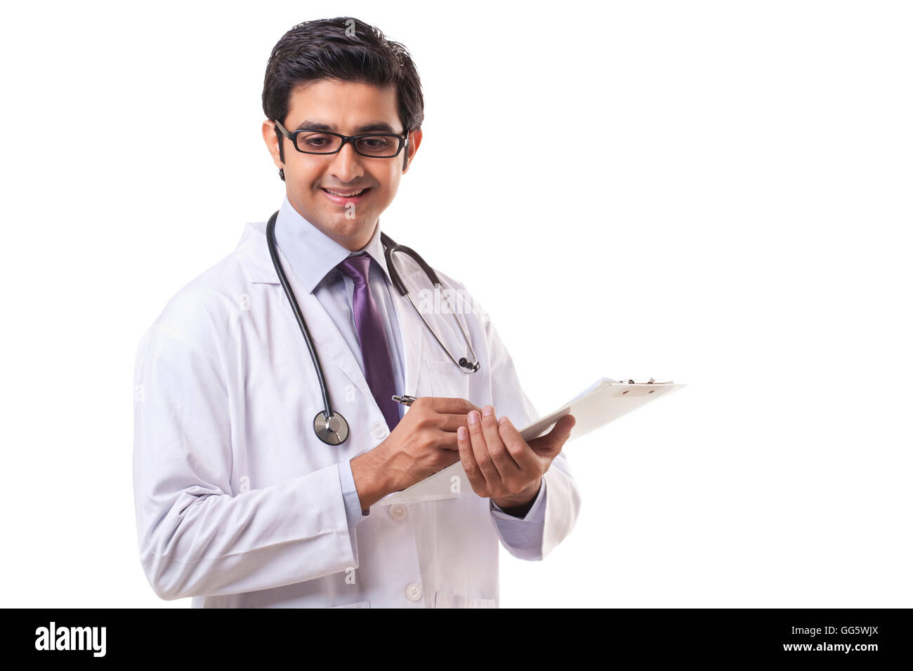 Happy male doctor writing on clipboard over white background Stock ...