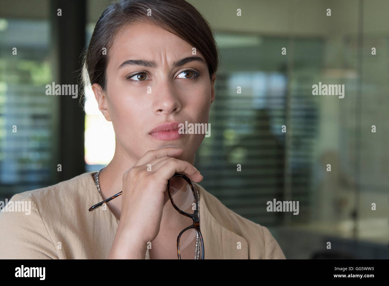 Close-up of a woman thinking Stock Photo - Alamy