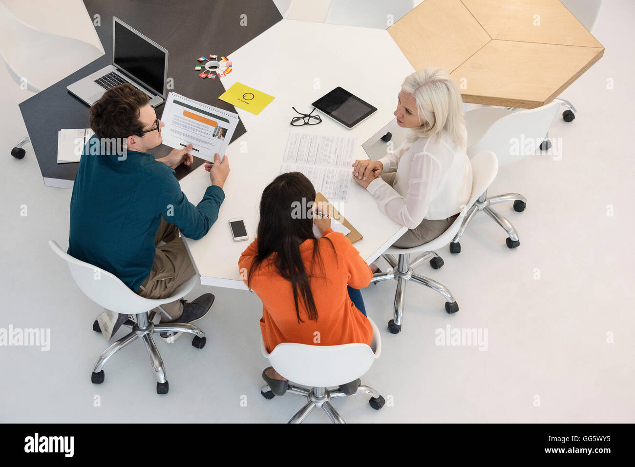 Three business people discussing in an office Stock Photo - Alamy