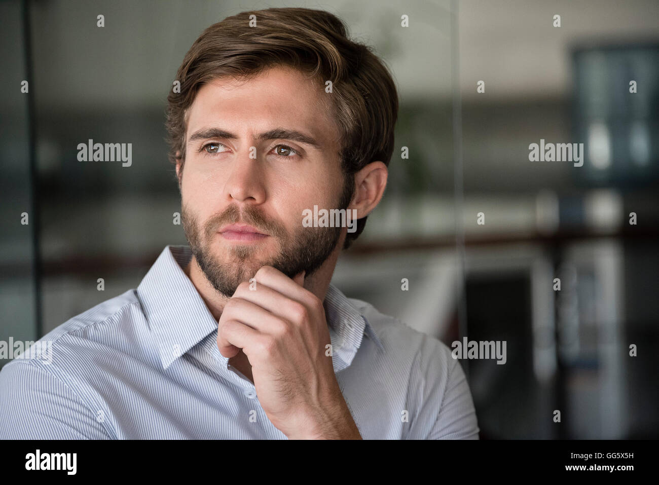 Close-up of a young man thinking Stock Photo - Alamy