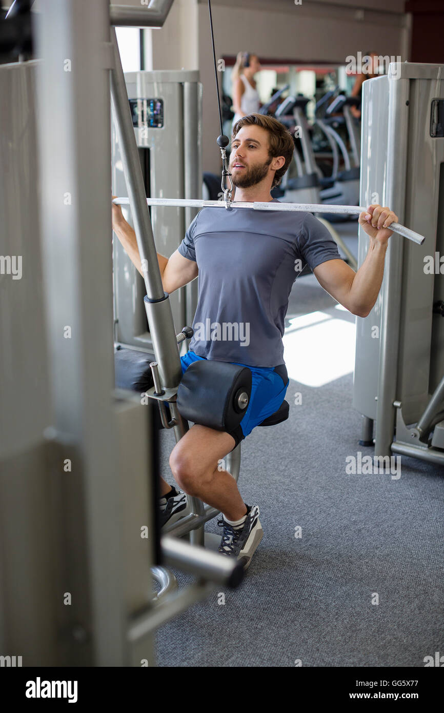 Young man exercising in a gym Stock Photo - Alamy