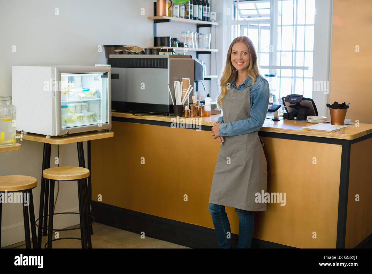 Happy waitress standing in a restaurant Stock Photo - Alamy