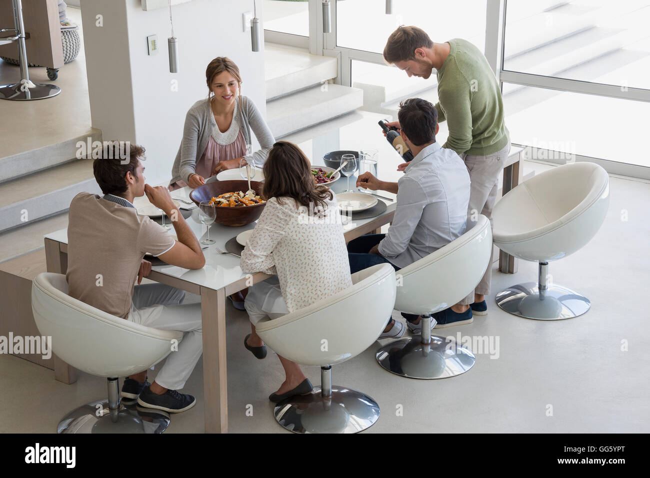 People sitting at dining table Stock Photo - Alamy