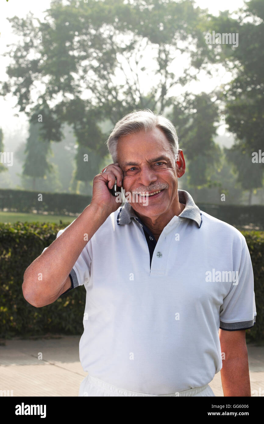 Portrait of old man talking on a mobile phone Stock Photo - Alamy