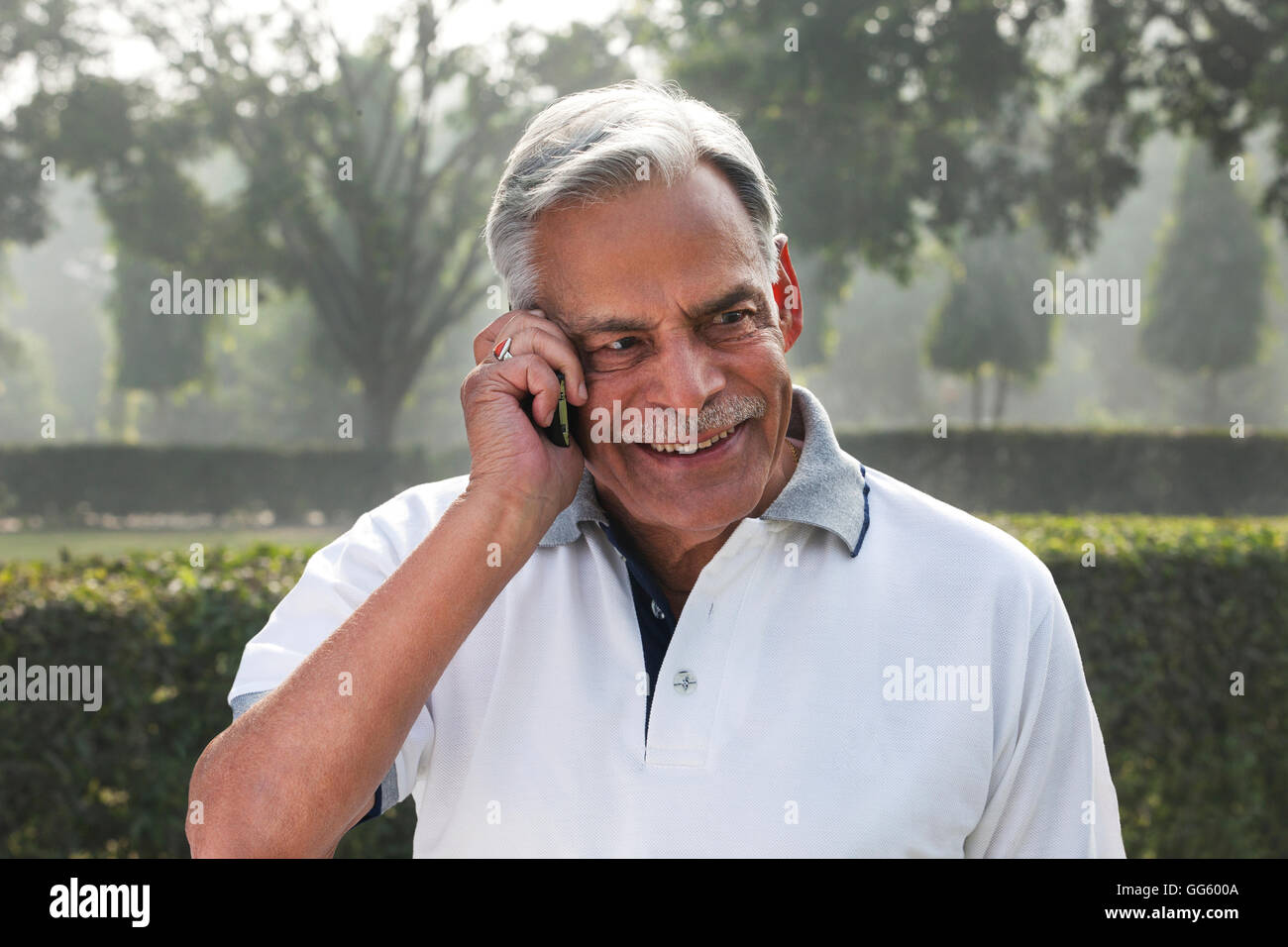 Old man talking on a mobile phone Stock Photo - Alamy