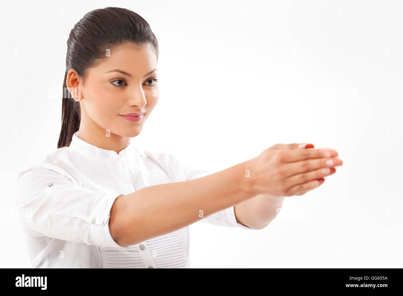 Close-up of woman with hands clasped doing yoga over white background ...