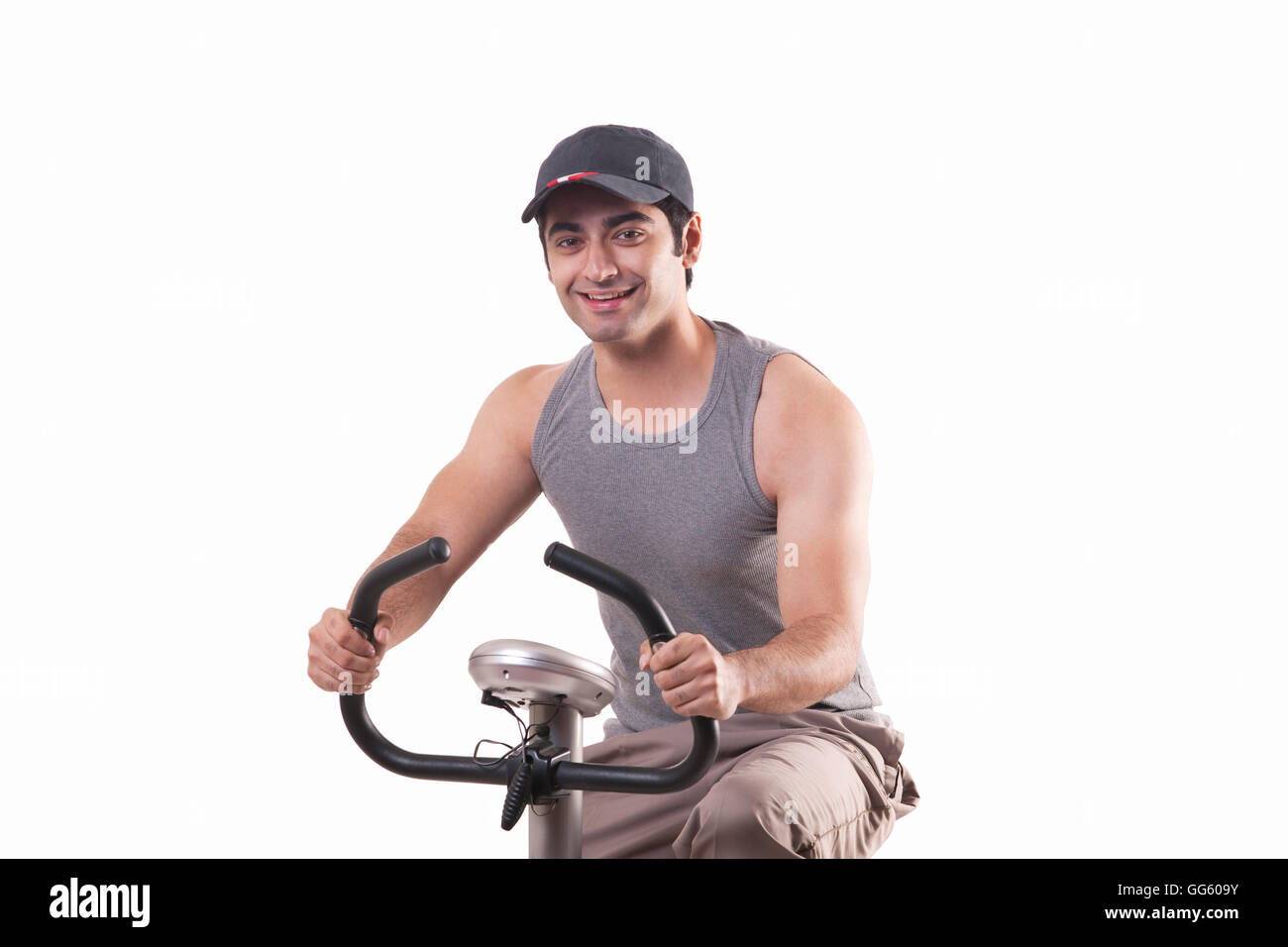 Portrait of a young man exercising over white background Stock Photo ...