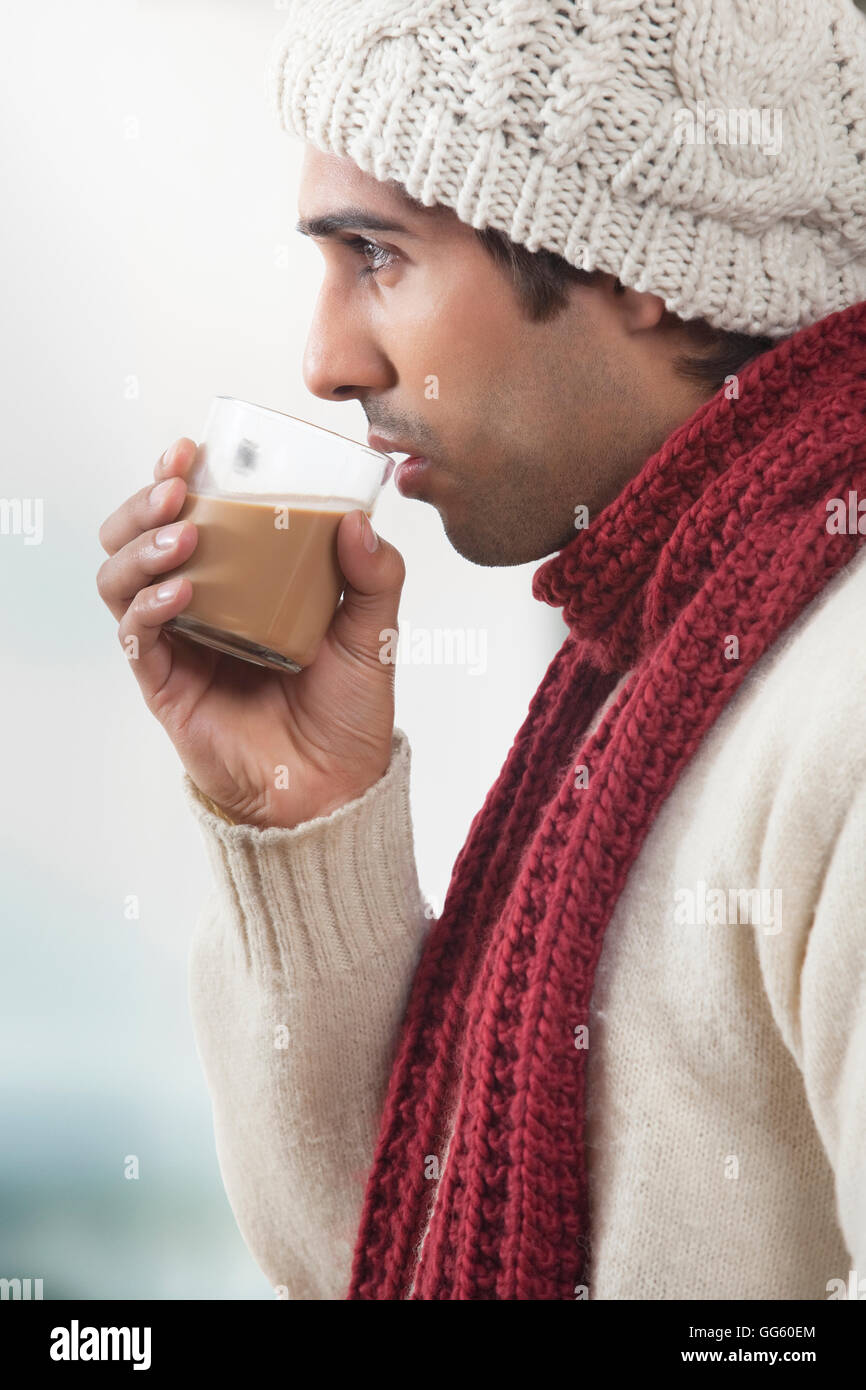 Young man drinking tea Stock Photo - Alamy